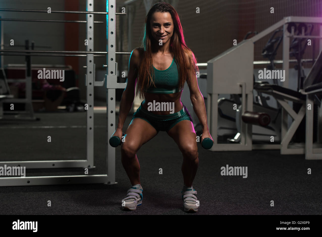 Young Woman Working Out Legs With Dumbbells - One Of The Best ...