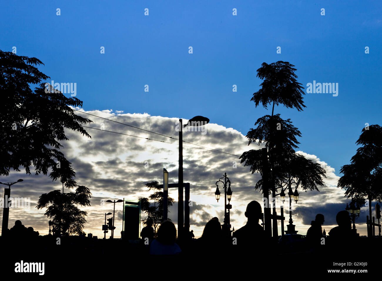Group of people on a square in the city at dusk Stock Photo - Alamy