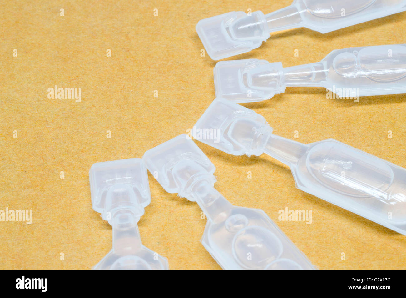 Artificial tear single use containers eye drop on yellow paper texture ...
