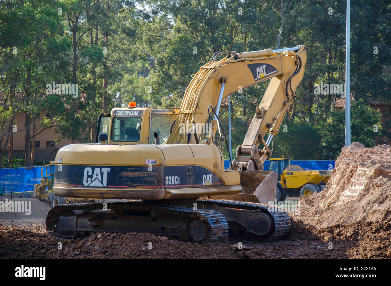 Excavators and earth moving equipment working on a construction site in ...