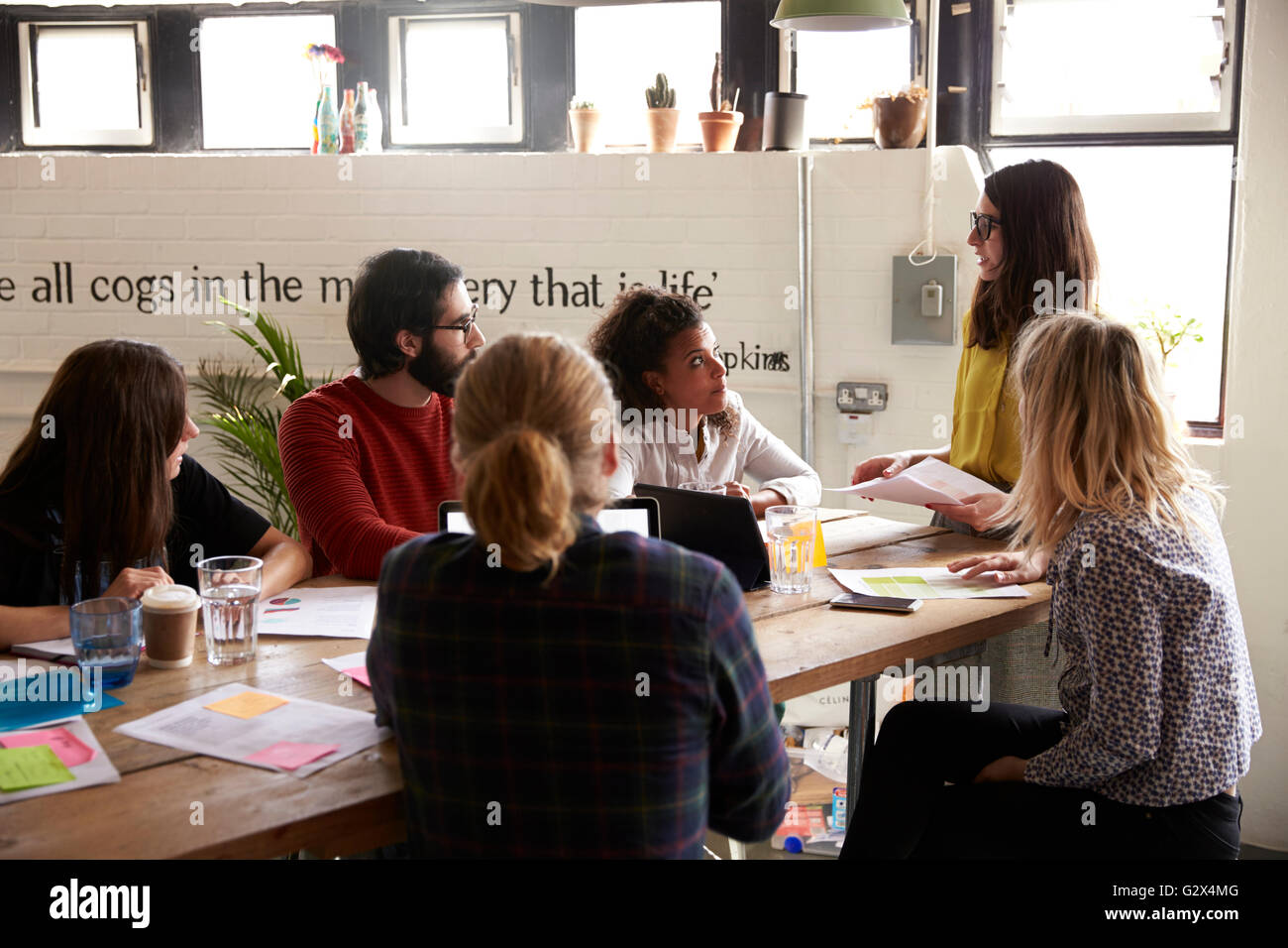 Female Manager Leads Meeting Around Table In Design Office Stock Photo ...