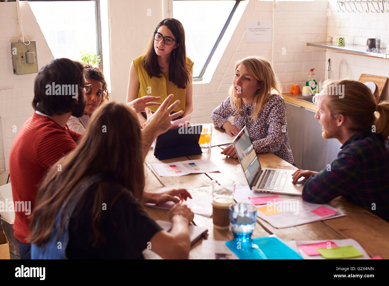 Female Manager Leads Meeting Around Table In Design Office Stock Photo ...