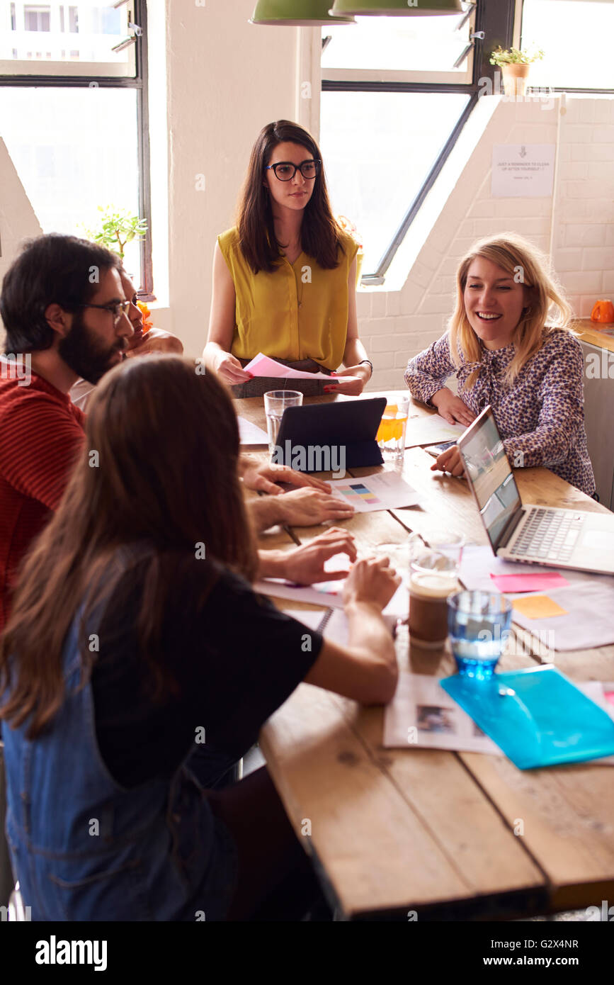 Female Manager Leads Meeting Around Table In Design Office Stock Photo ...
