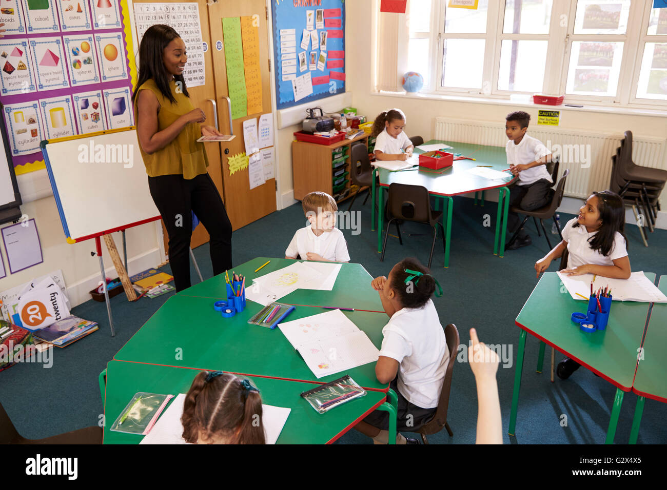 Teacher With Digital Tablet In Elementary School Classroom Stock Photo ...