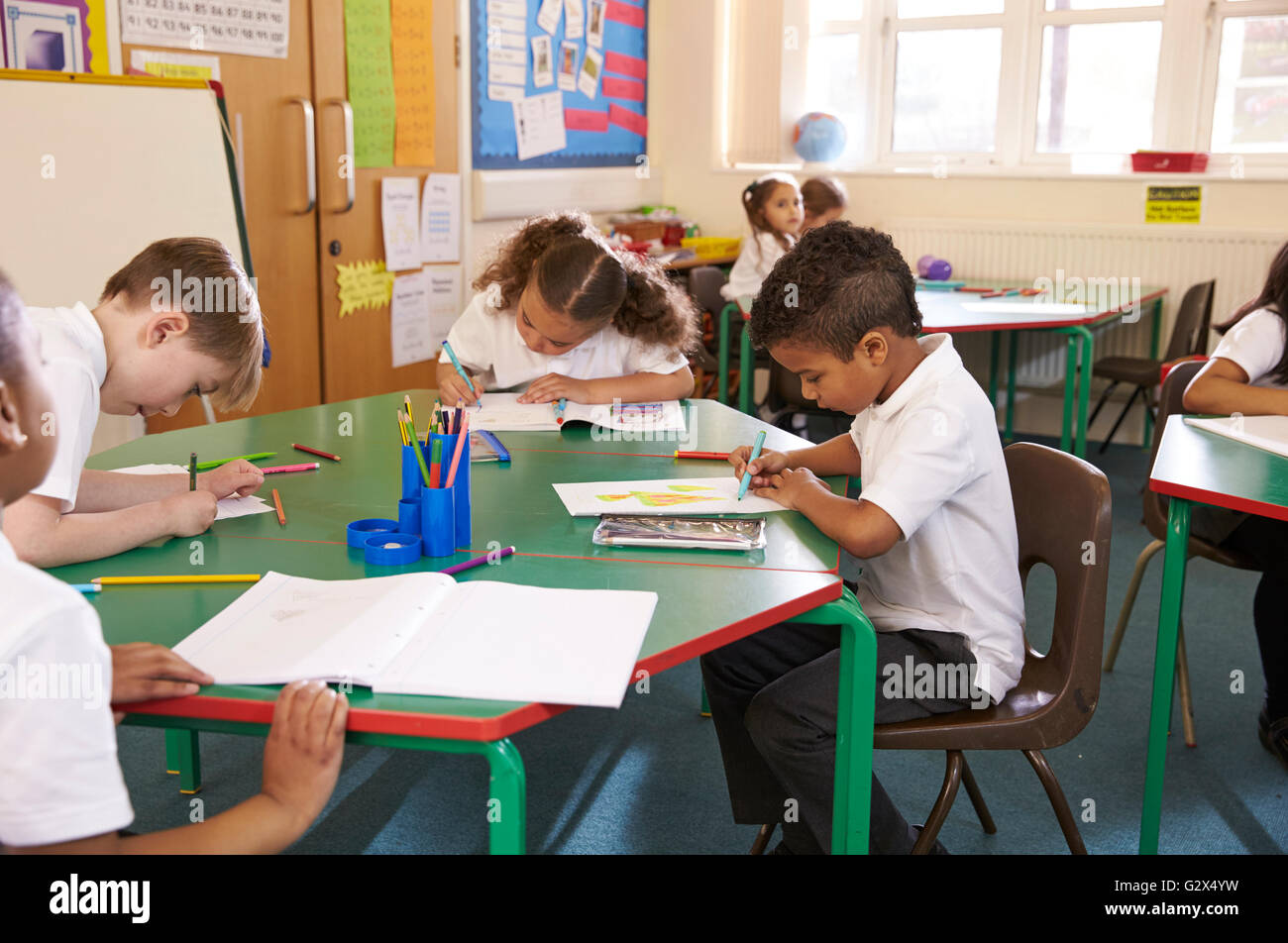 Pupils Working At Desks In Elementary School Classroom Stock Photo - Alamy
