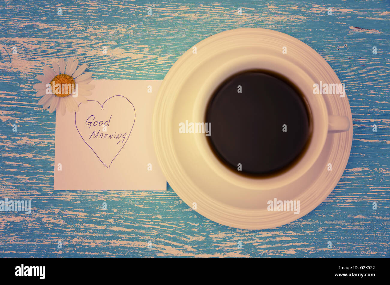 Cup of tea with good morning note on rustic blue wooden background. Top ...