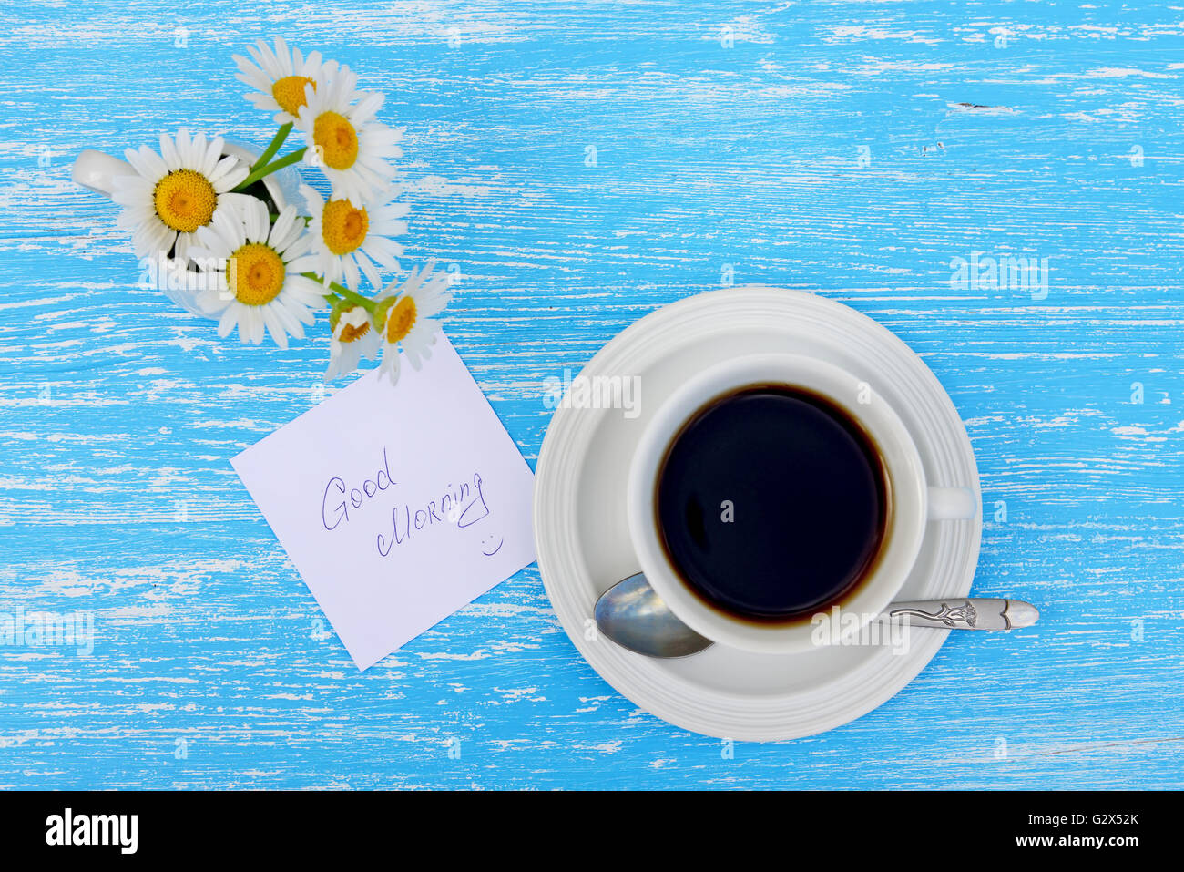 Cup of tea with good morning note on rustic blue wooden background. Top ...