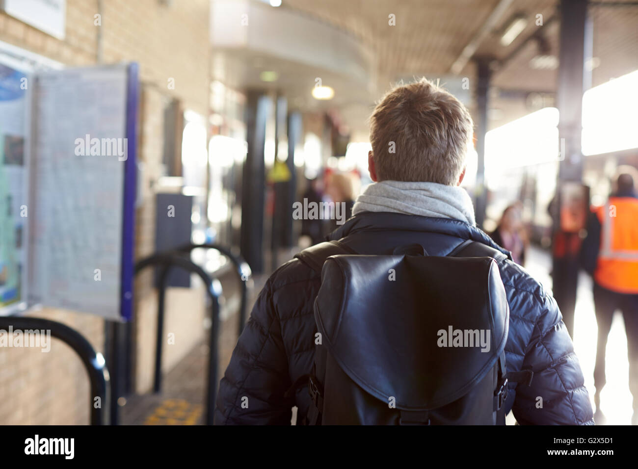 Rear View Of Commuter With Backpack On Railway Platform Stock Photo - Alamy