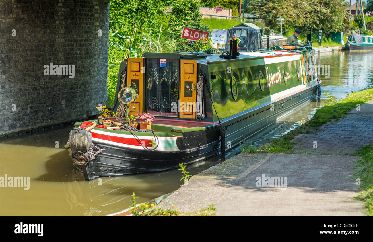 Canal boat passes under a bridge on the Trent and Mersey Canal near the ...
