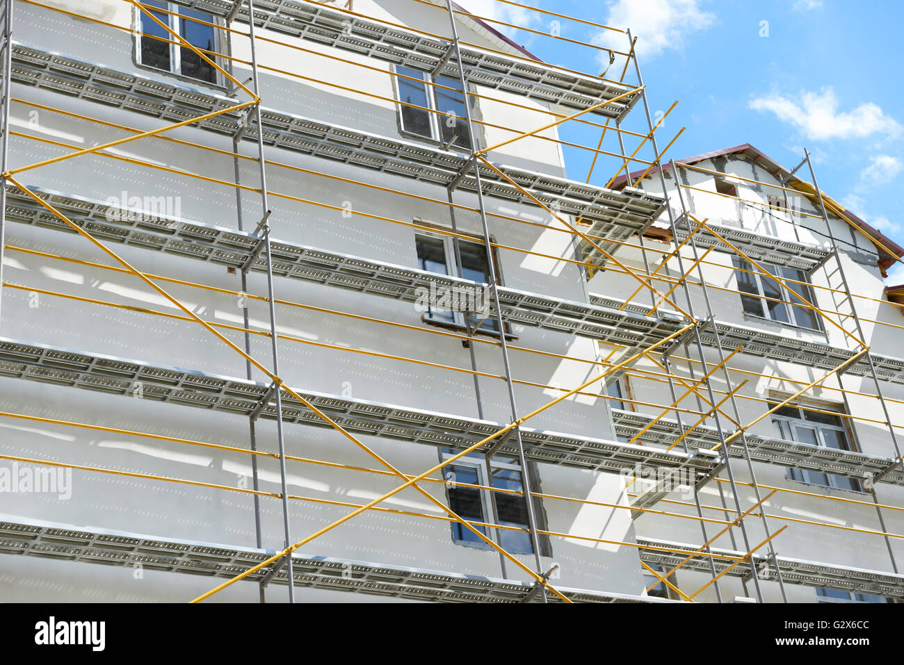 scaffolding near a house under construction for external plaster works ...