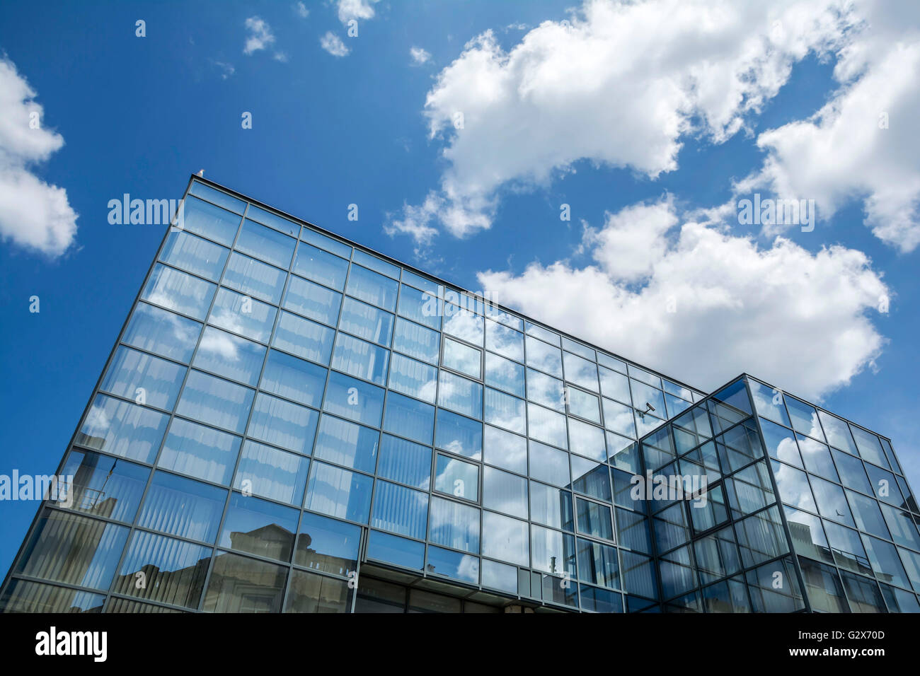 Building facade with blue sky and white clouds Stock Photo - Alamy