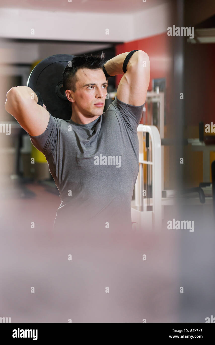 health club: guy in a gym doing weight lifting Stock Photo - Alamy