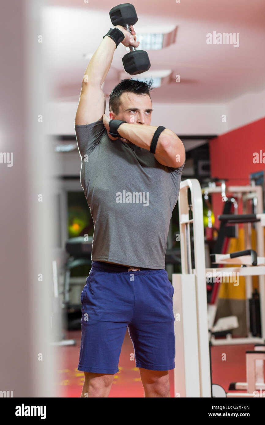 muscular man lifting dumbbell at the gym Stock Photo - Alamy