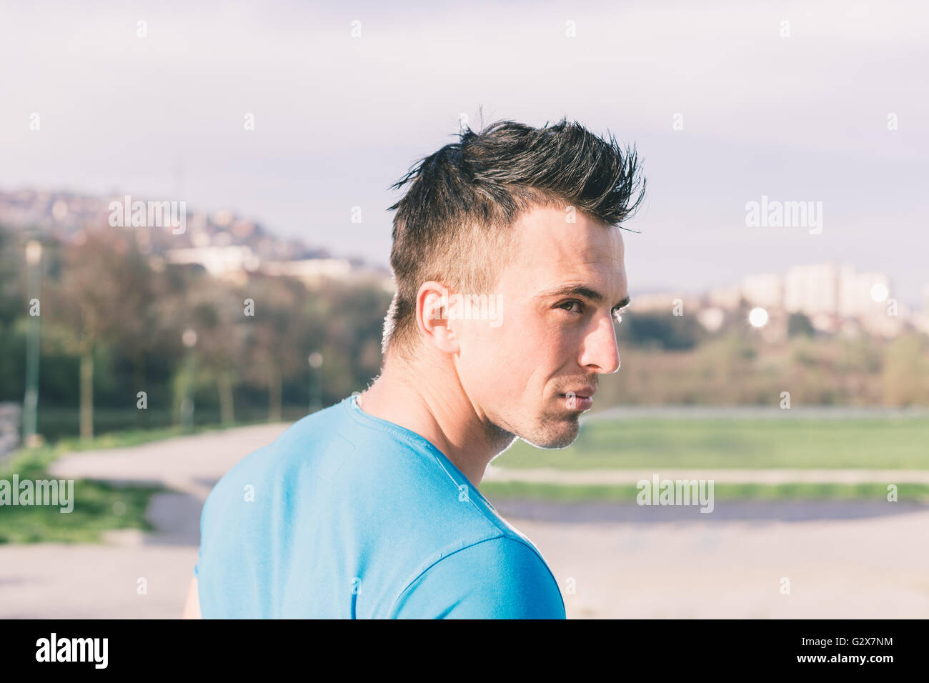 Focused handsome athlete resting after long run Stock Photo - Alamy