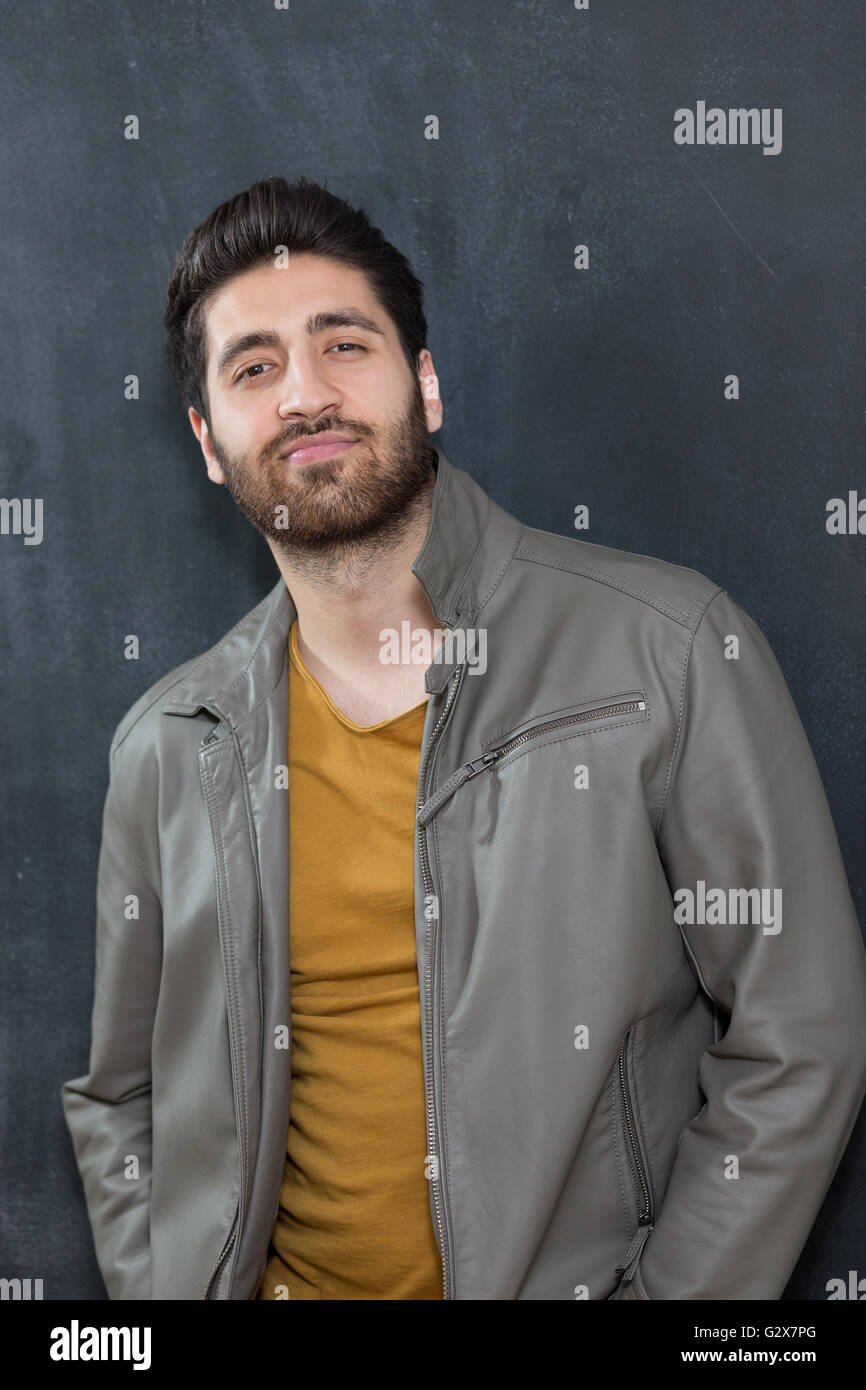 Portrait of masculinity. Portrait of handsome young bearded manstanding ...