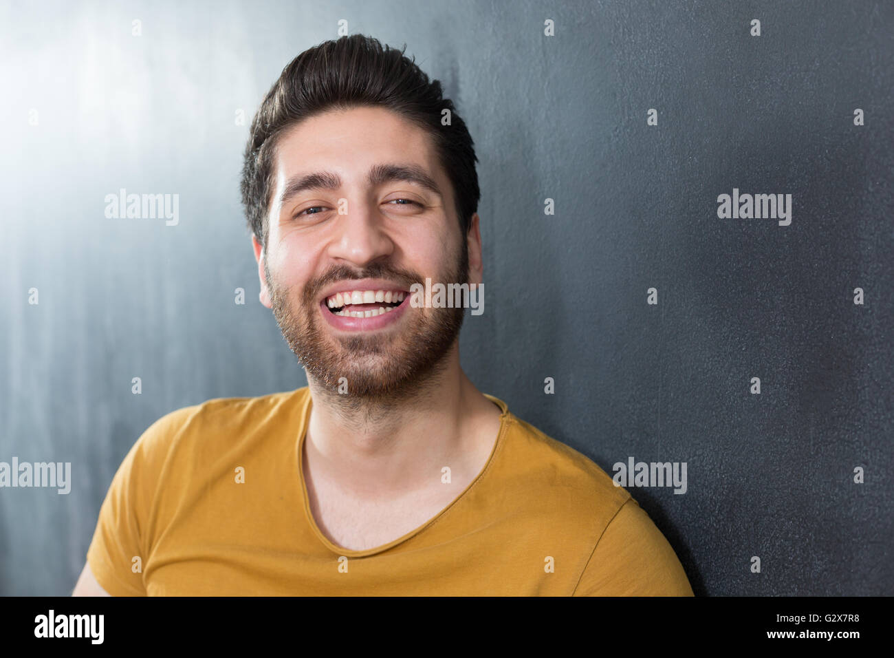 Smiling casual man close up portrait against dark background Stock ...