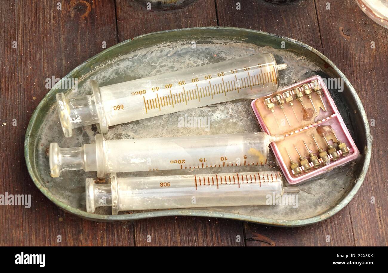 Old medical syringes and hypodermic needles in corroded tray Stock ...