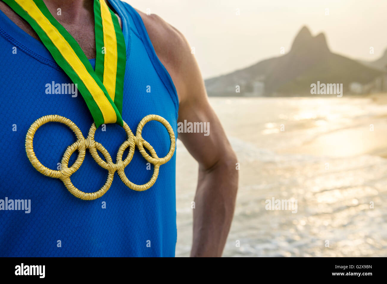 RIO DE JANEIRO - MARCH 20, 2016: Athlete stands wearing Olympic rings ...