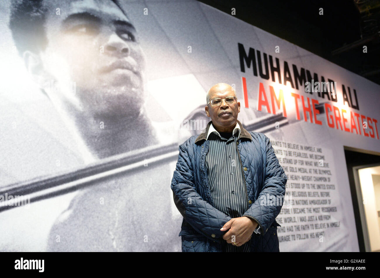 Winston Dottin, who met Muhammad Ali in 1974, poses beside a photograph ...