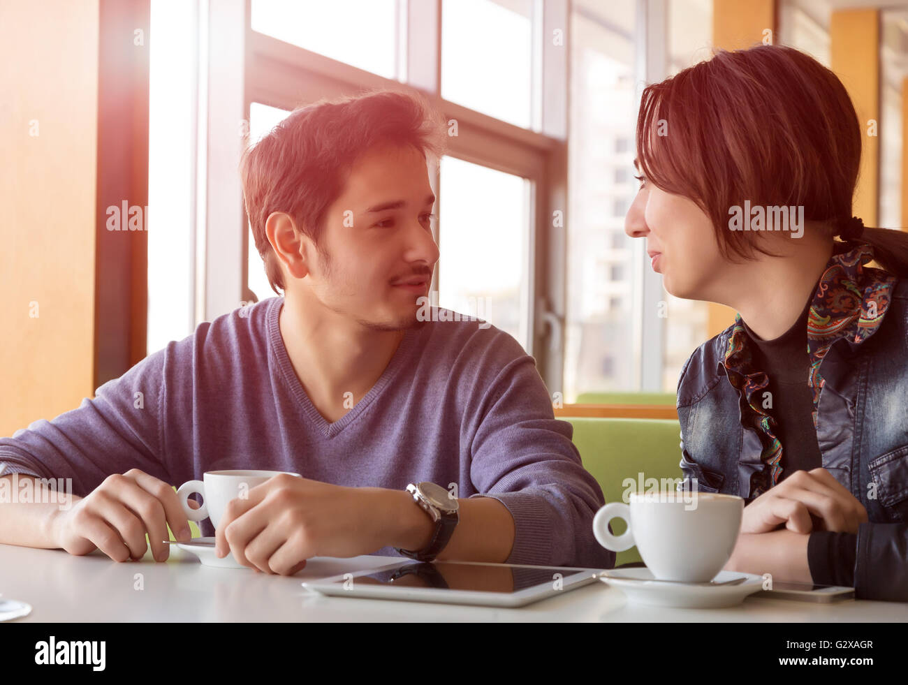 Young Couple at Coffee Shop Talking Stock Photo - Alamy