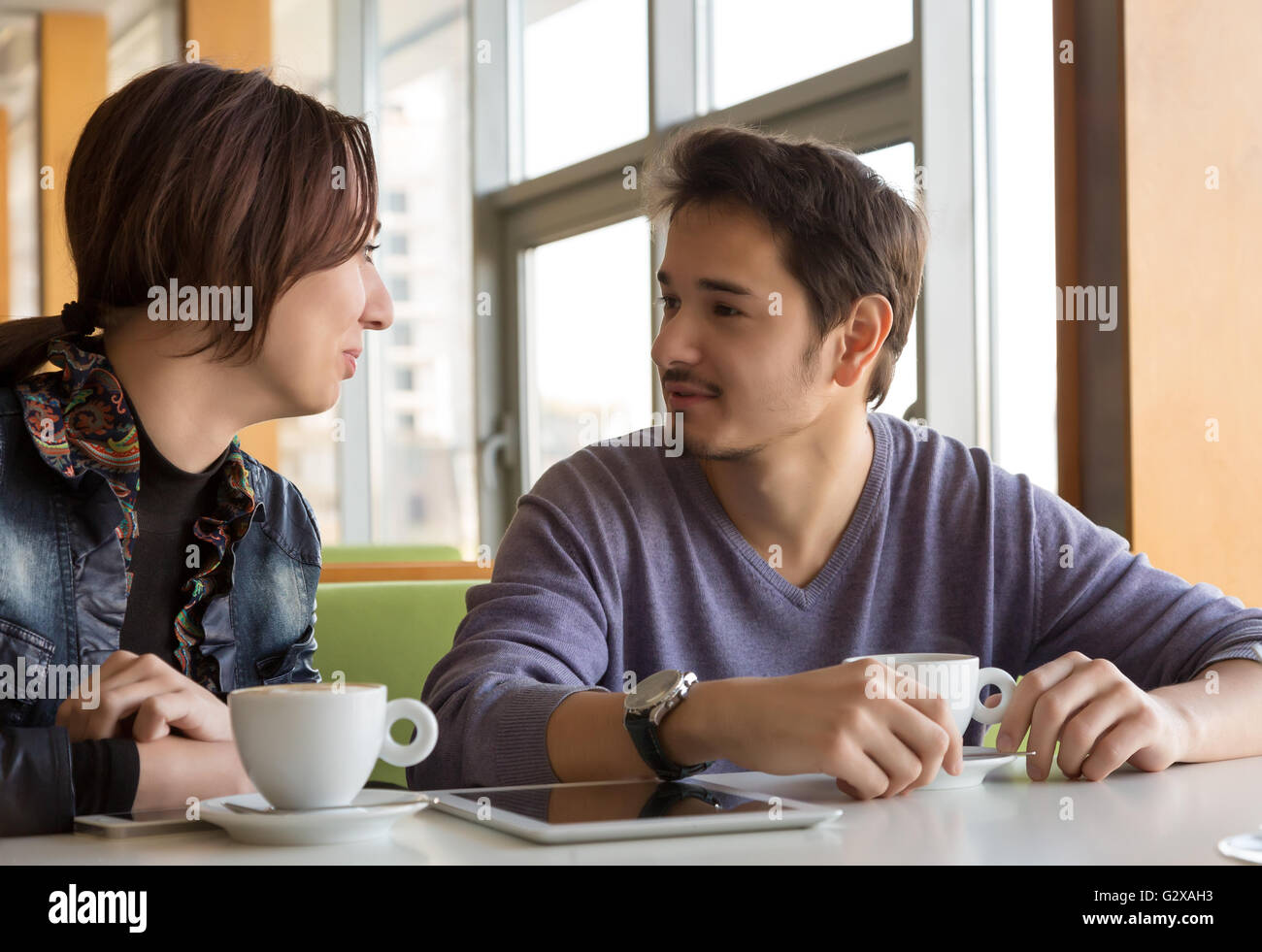 Young Couple at Coffee Shop Talking Stock Photo - Alamy