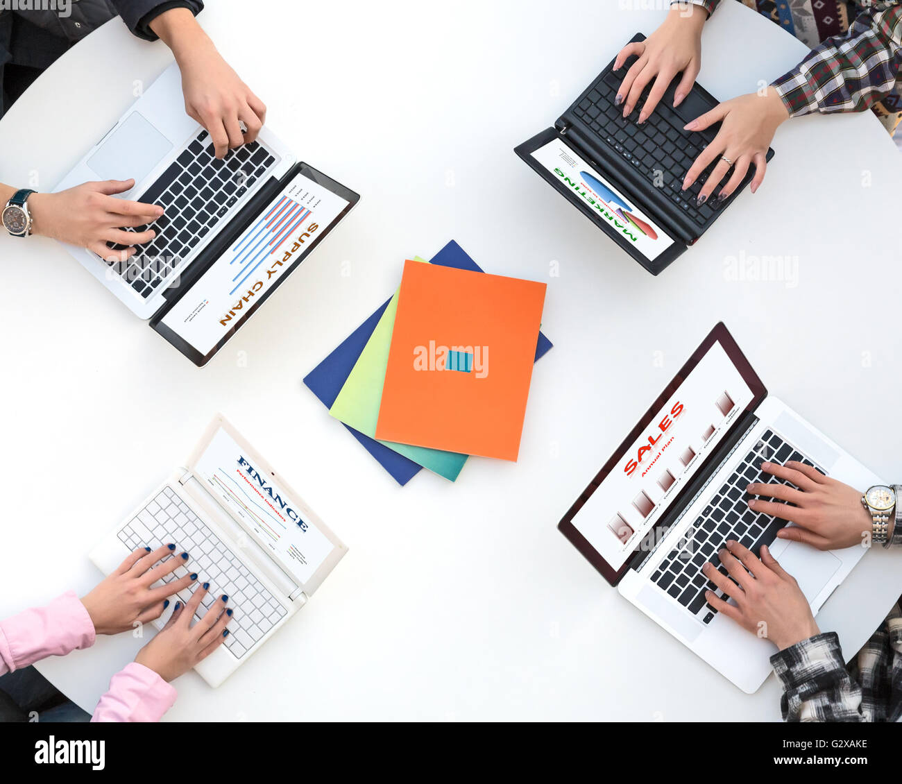 Top View of White Rounded Desk with Four Laptops and People Hands ...