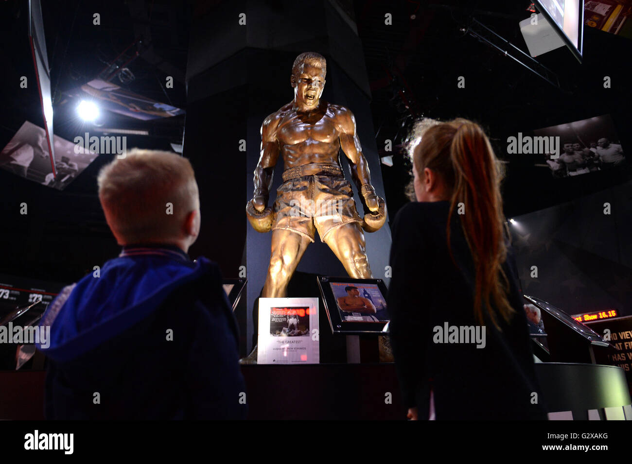 Visitors look at a statue of Muhammad Ali on display at the Muhammad ...