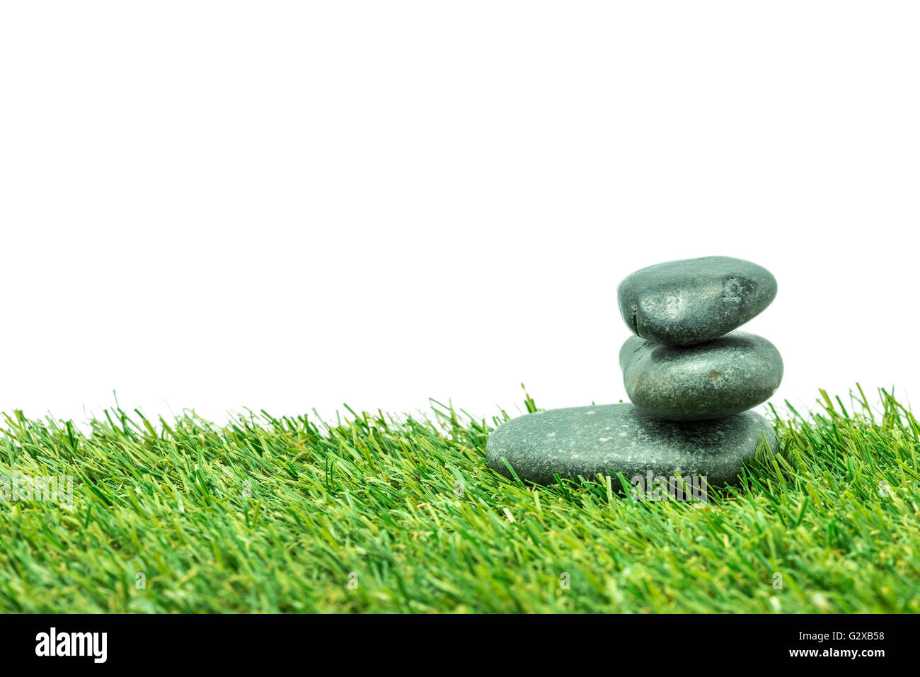 Stone with green grass Stock Photo - Alamy
