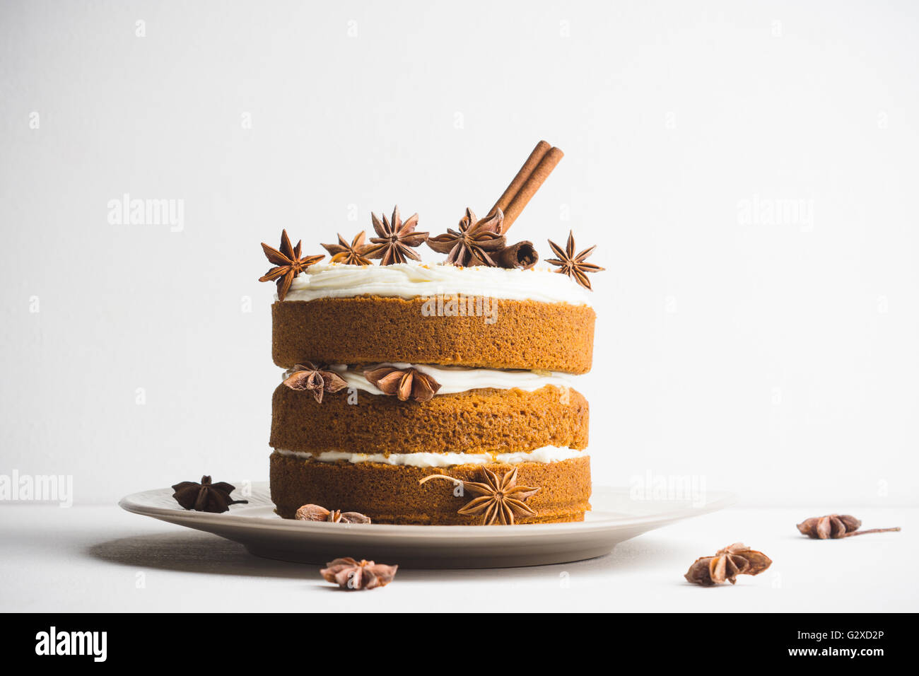 Cake with white cream and spices on the white wooden background Stock ...
