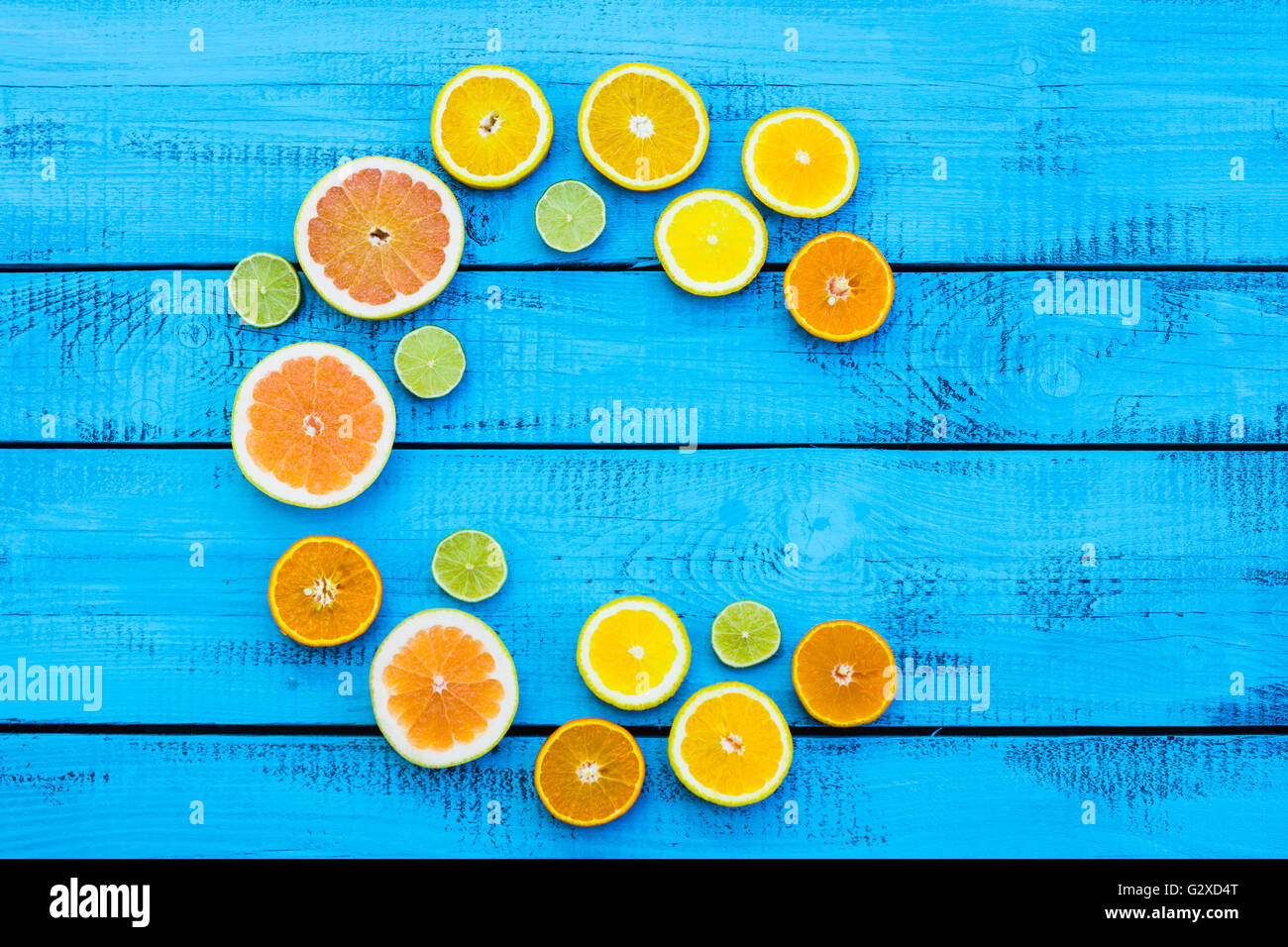 Letter C made of citrus fruits on the rustic blue background. Flat lay ...