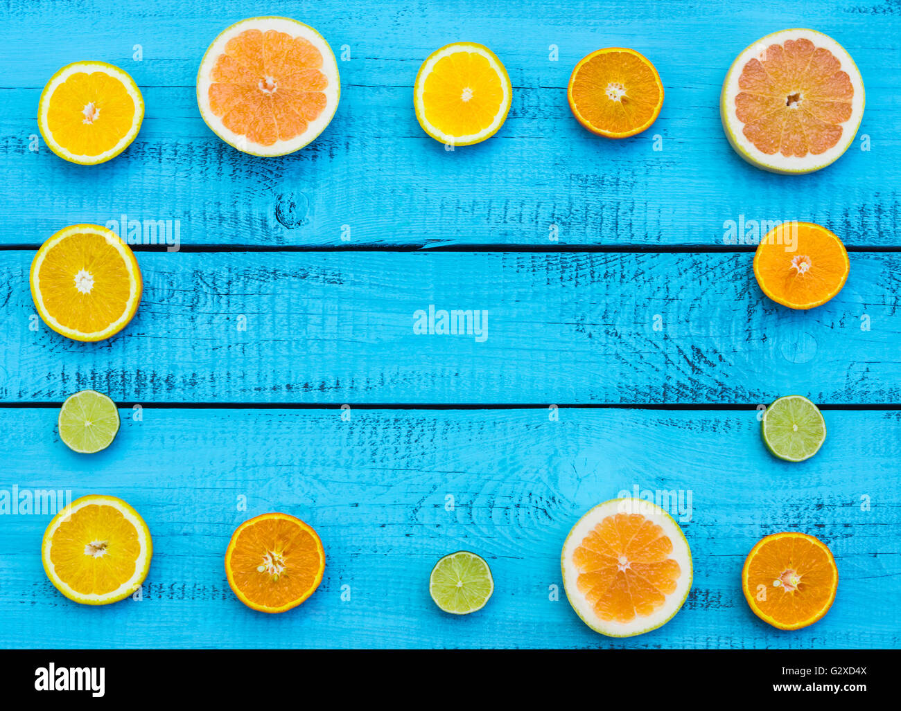 Colorful citrus fruits on the rustic blue background. Flat lay Stock ...