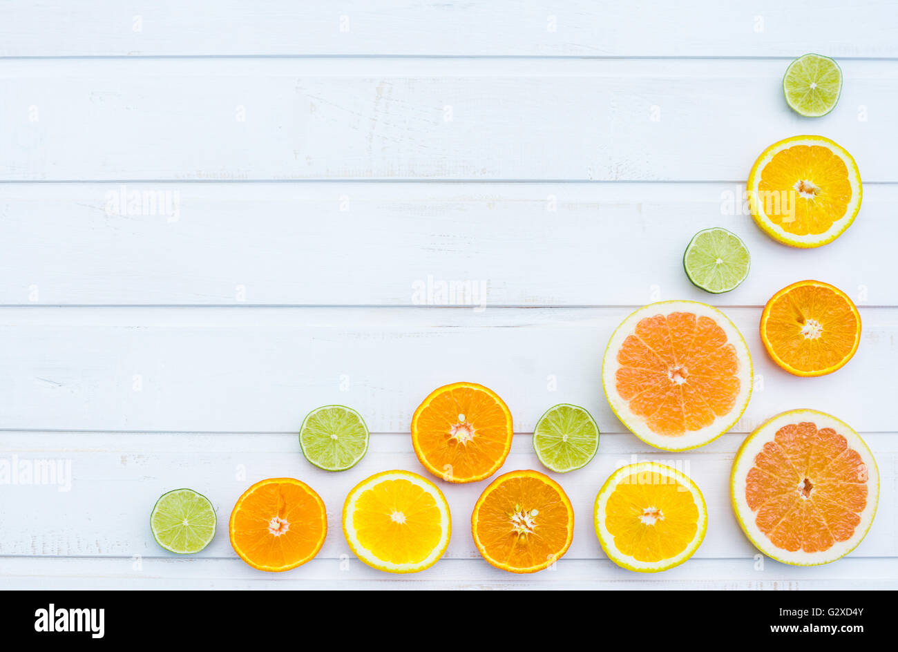 Colorful citrus fruits on the rustic white background. Flat lay Stock ...