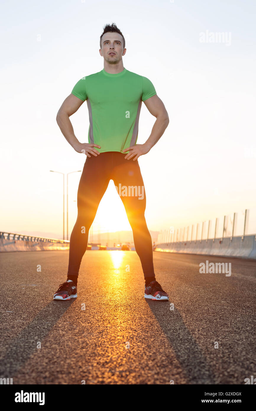 Stretching after jogging. sunset shot on highway Stock Photo - Alamy