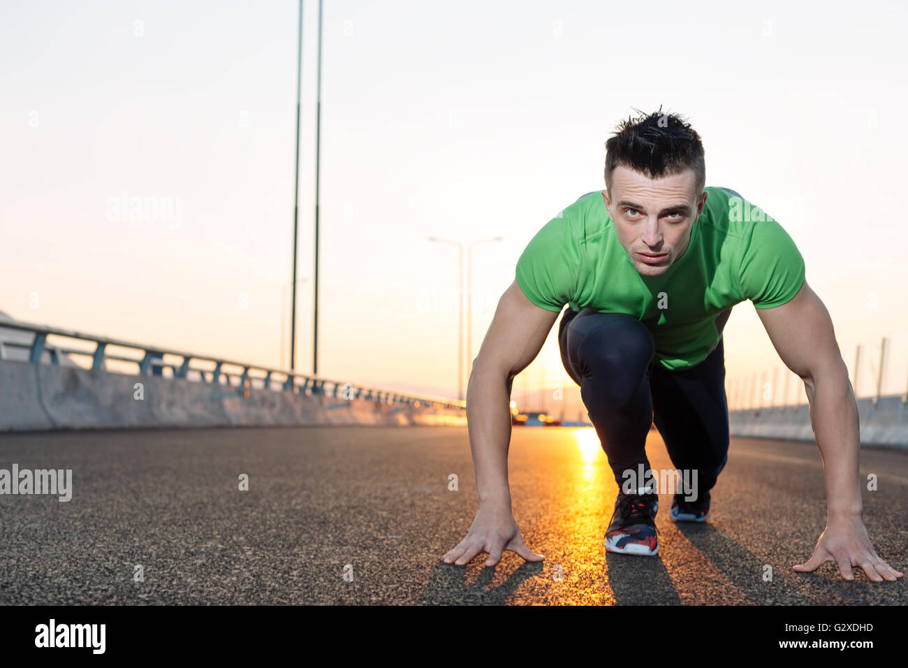 Fit and confident man in starting position ready for running. Male ...