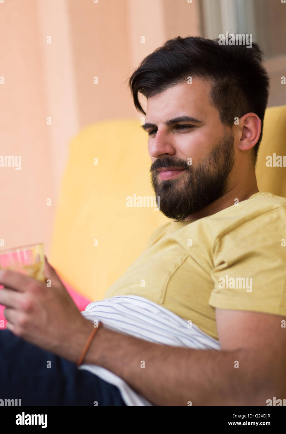 Inspired with cup of fresh coffee. Handsome young man drinking coffee ...
