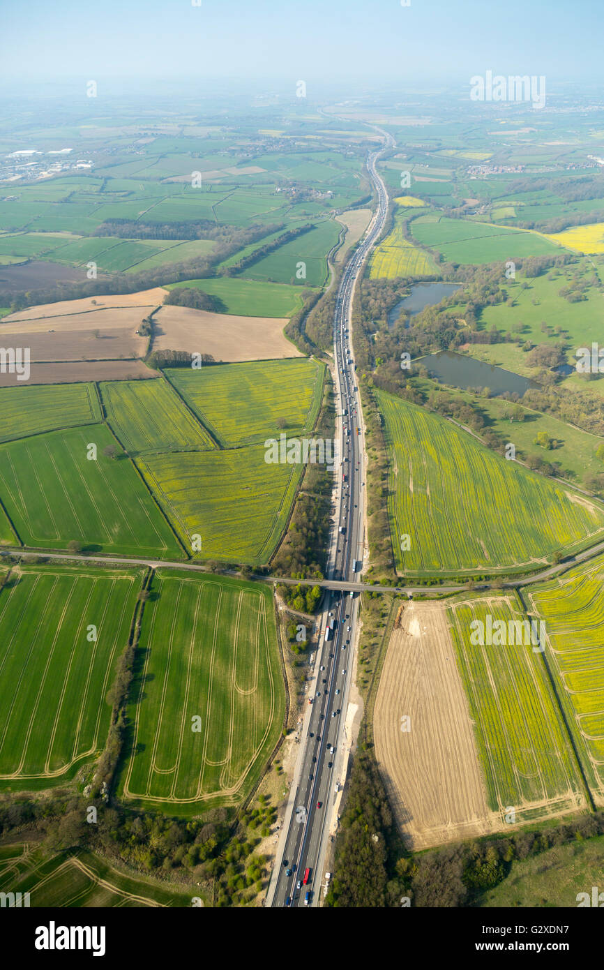 Aerial view of traffic on M1 motorway going through countryside in ...