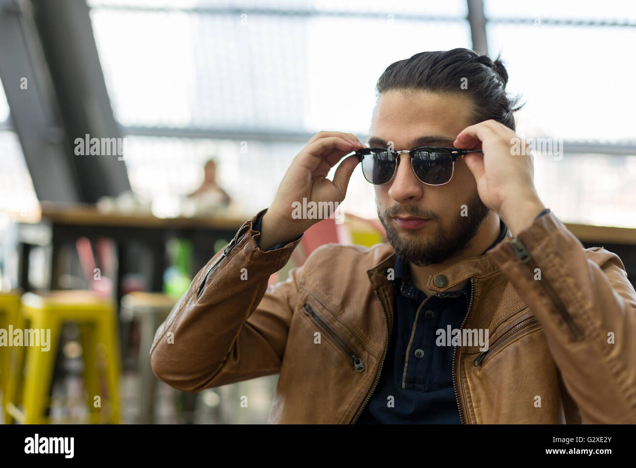 stylish hipster model with long hair and beard lifestyle in the street ...