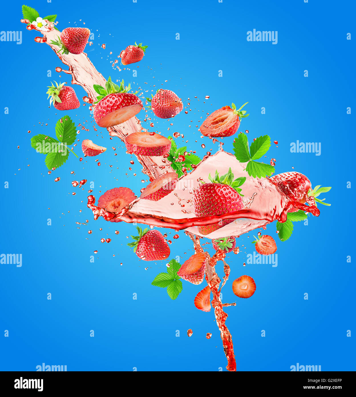 strawberry juice splash on the blue background Stock Photo - Alamy
