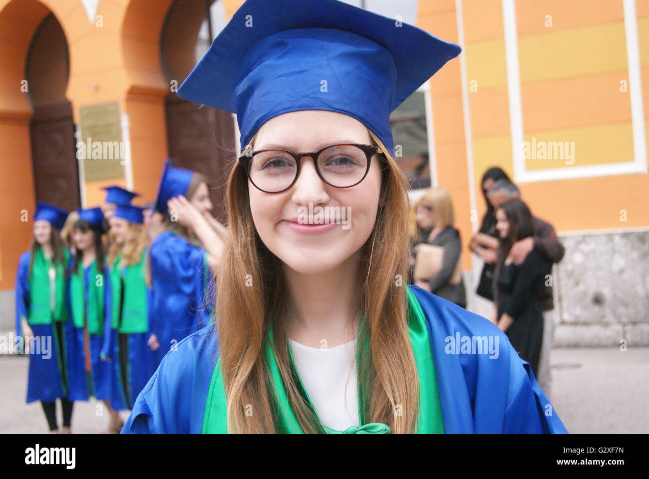 Graduate students wearing graduation hat and gown, outdoors Stock Photo ...