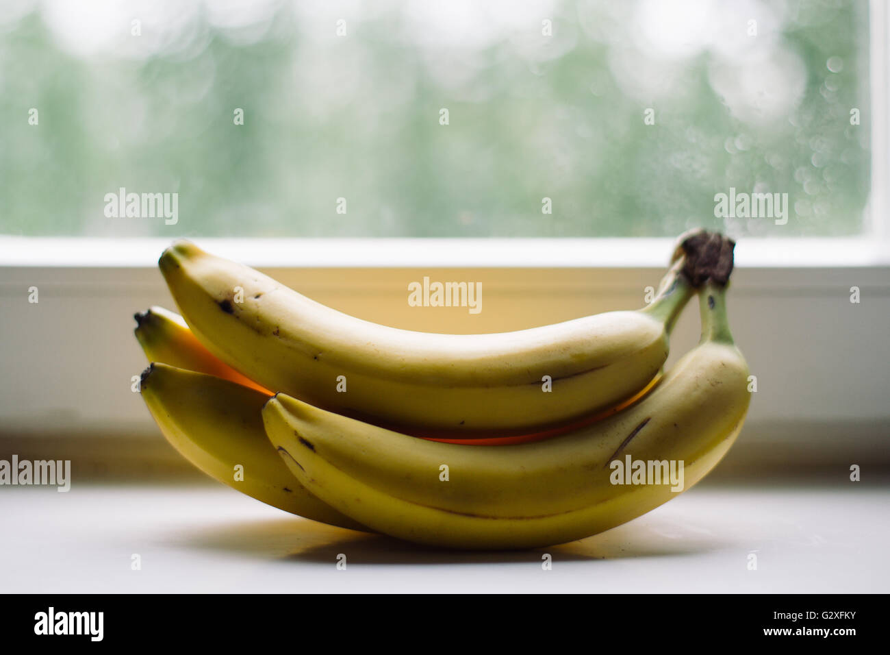 bunch of bananas on the window Stock Photo - Alamy