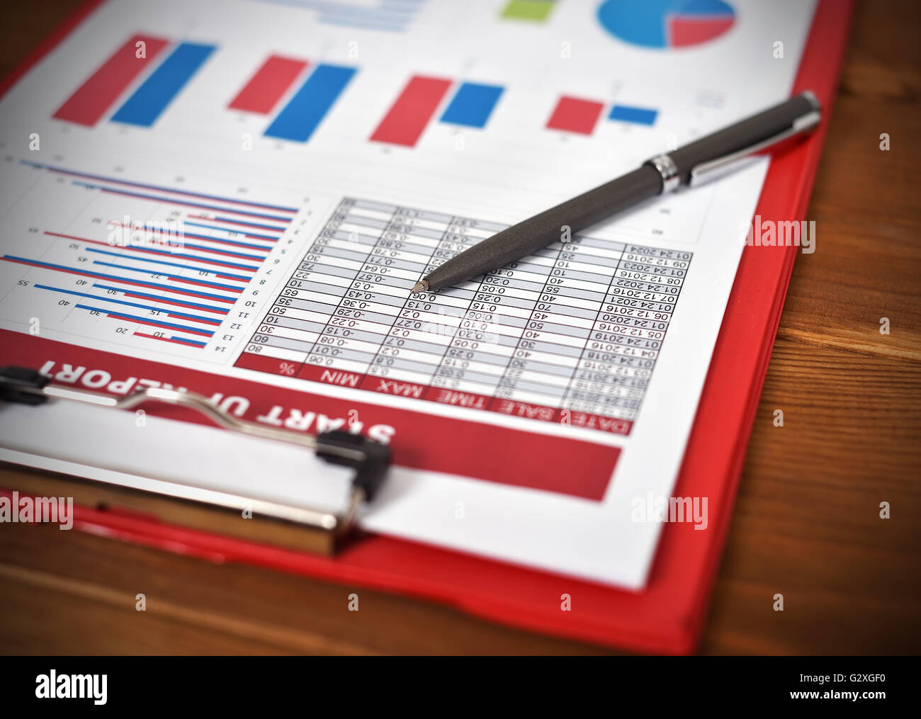 Start up report with charts and tables on table Stock Photo - Alamy