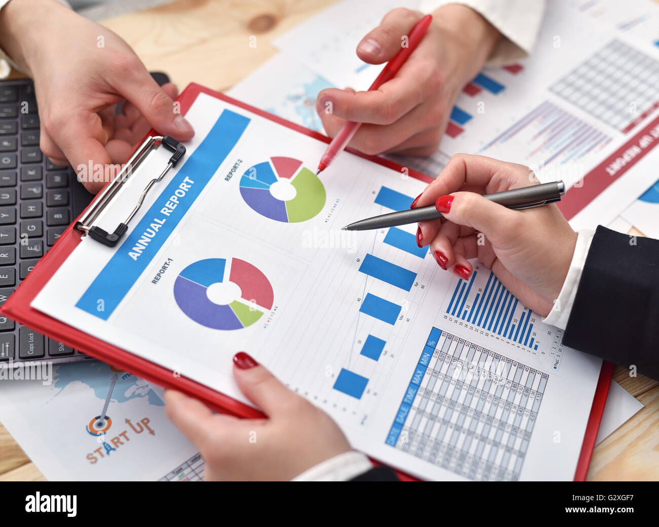 human hands analyzing the business diagrams on foreground Stock Photo ...