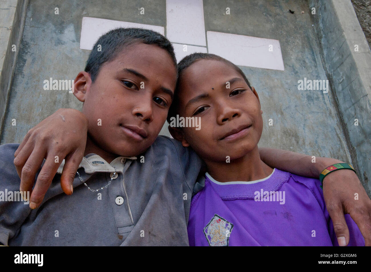 Flores, Luba Village, two villager male boys, Christian cross in the ...