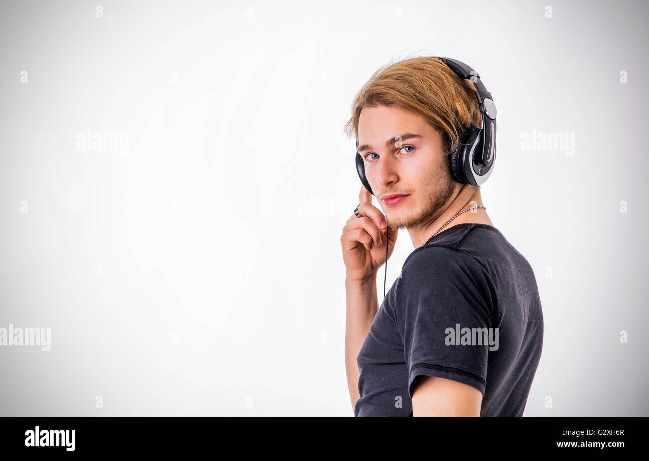 Handsome young man listening hi-res stock photography and images - Alamy