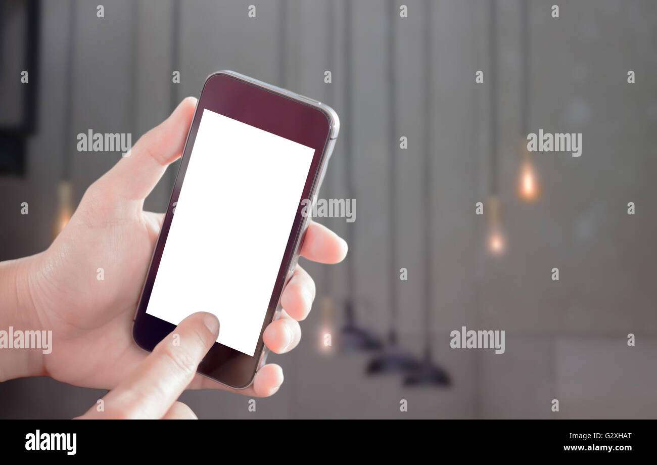 Hand holding smart phone with light blurred background, stock photo ...