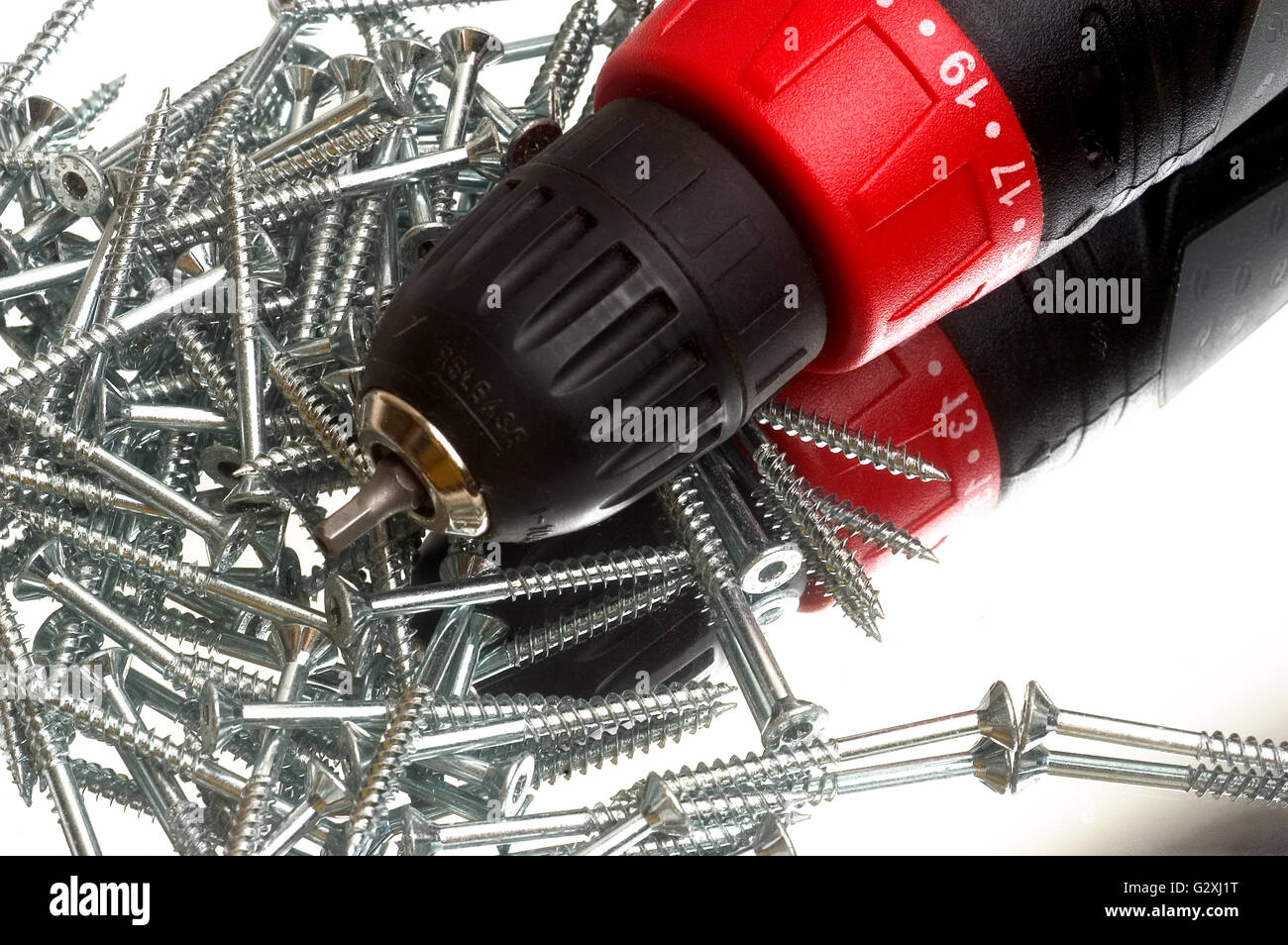 A screwing, unscrewing screws with a bunch photographed in studio to ...