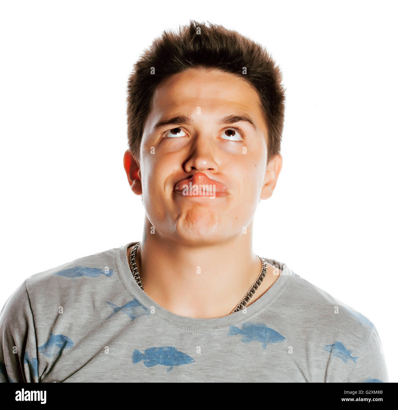 young pretty boy making silly faces isolated on white background ...