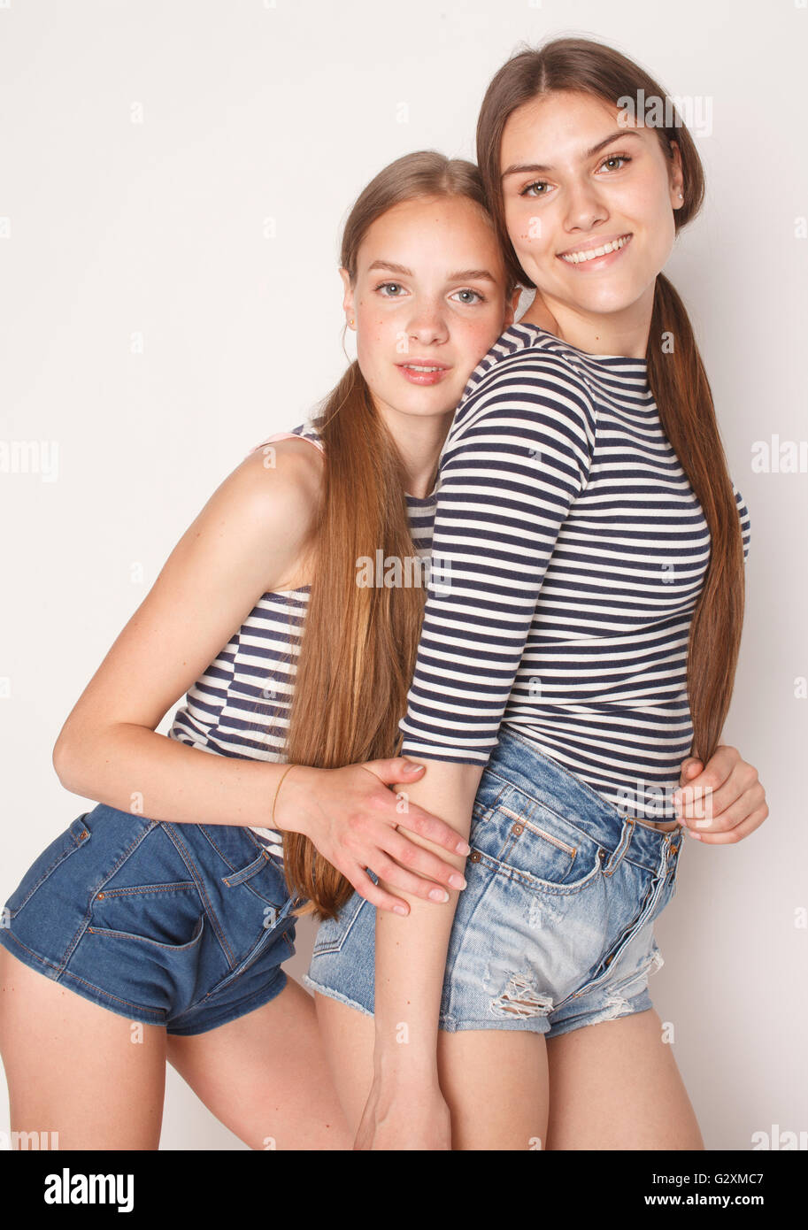 two cute teenagers having fun together isolated on white Stock Photo ...