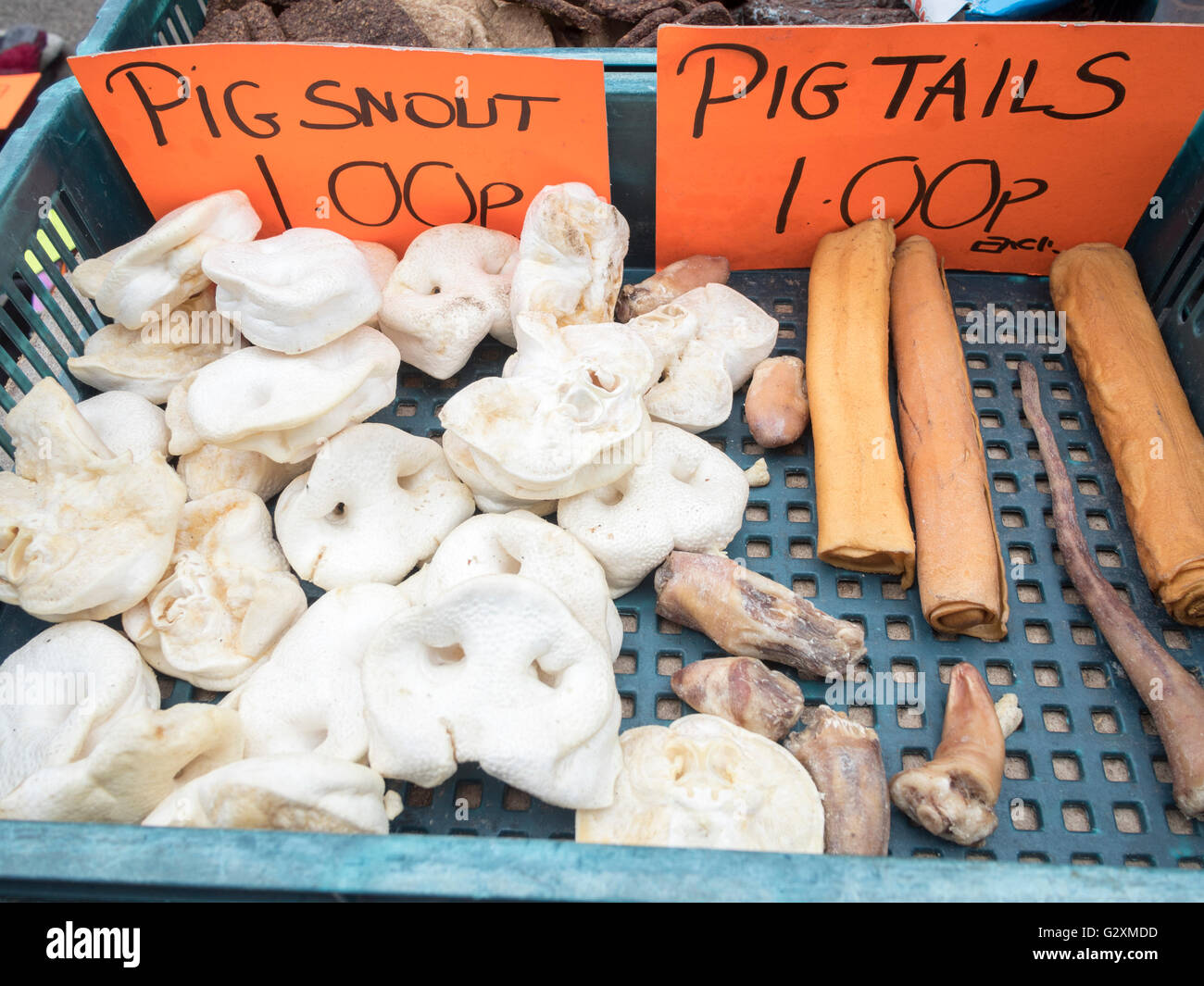 A collection of pigs' snouts for sale at a pet-food stall at a market ...