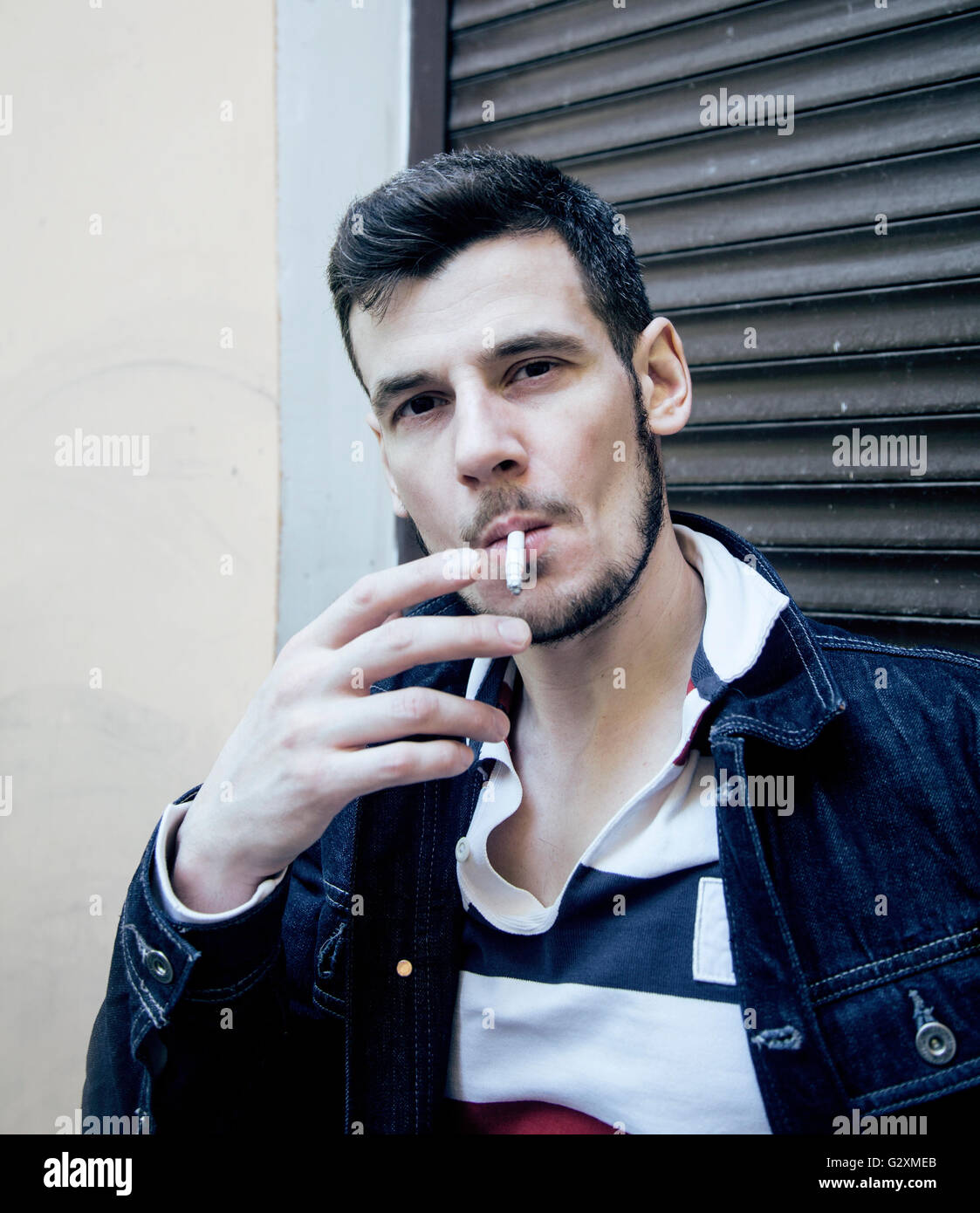 middle age man smoking cigarette on backjard, stylish tough guy ...